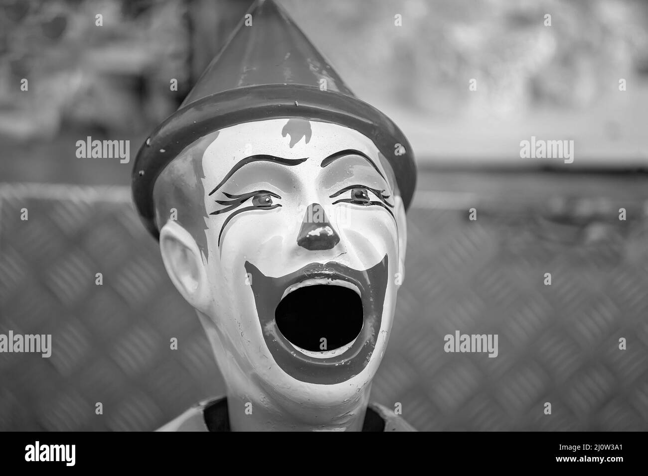 A painted clown figurine with open mouth ready for child to put in a ...