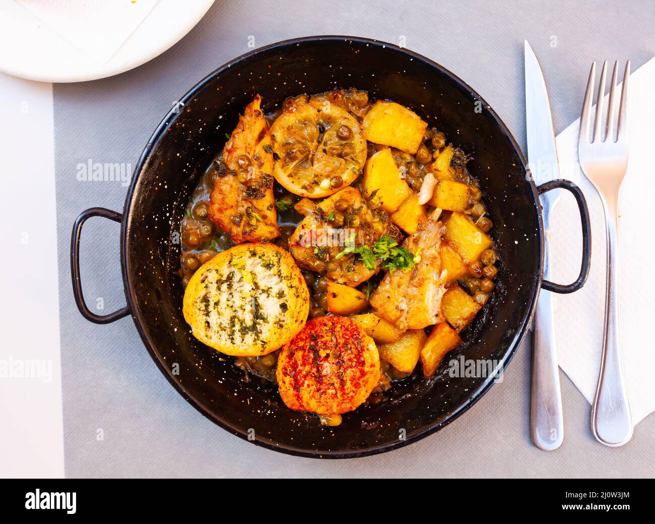 Fish in lemon sauce - dish of Valencian cuisine Stock Photo - Alamy