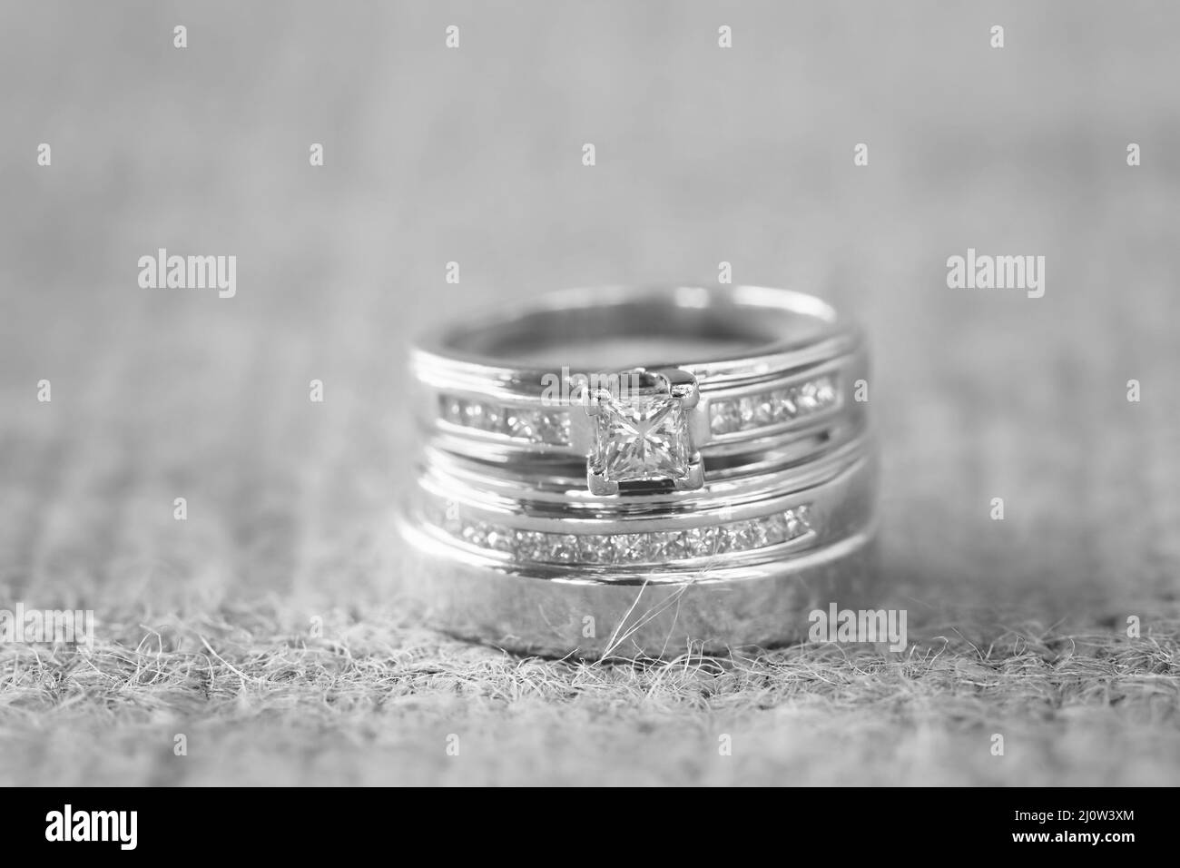 Wedding rings stacked on a textured surface Stock Photo - Alamy