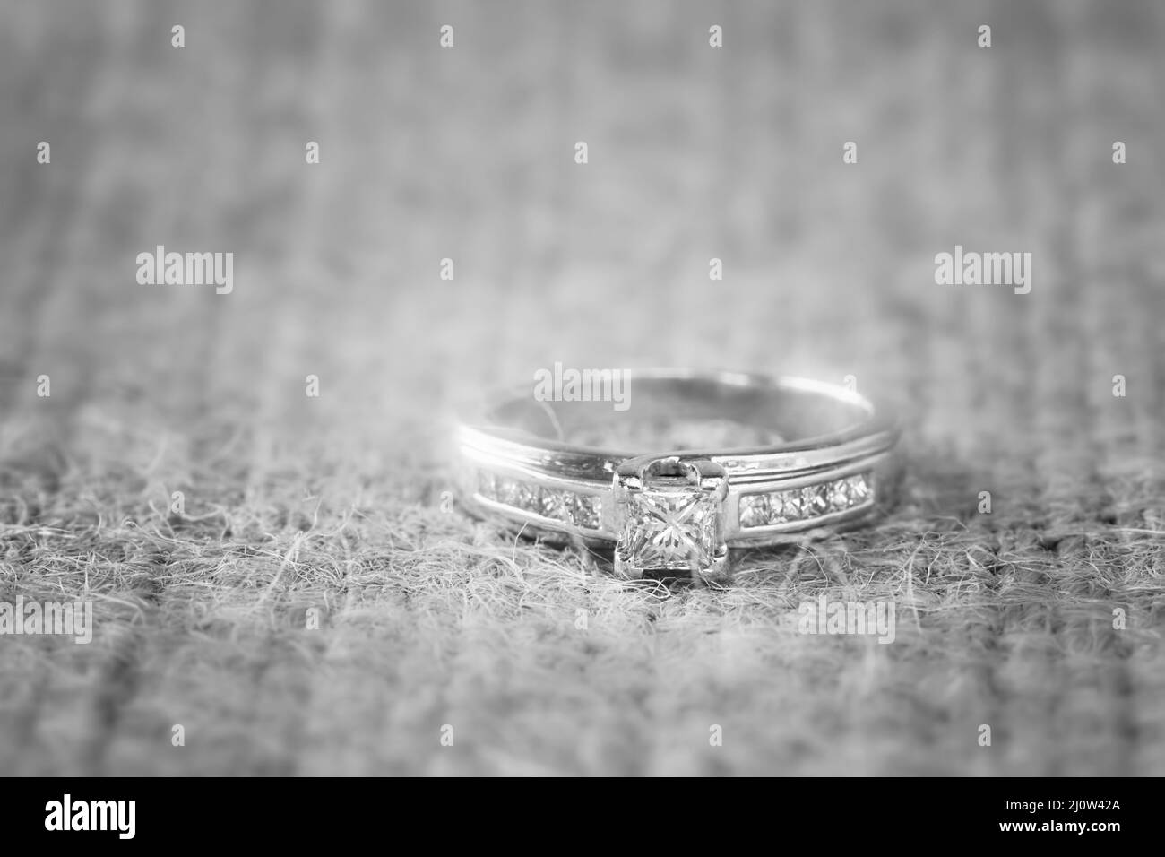 Diamond engagement ring on a textured surface Stock Photo - Alamy