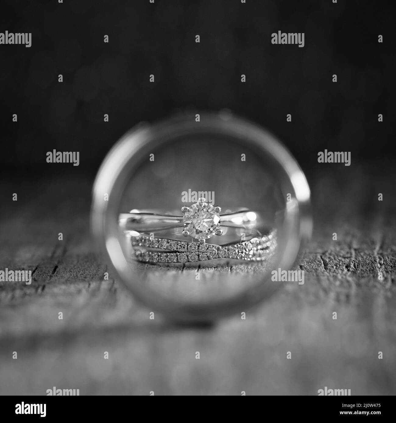 Bride's wedding and engagement rings photographed through the circle of ...
