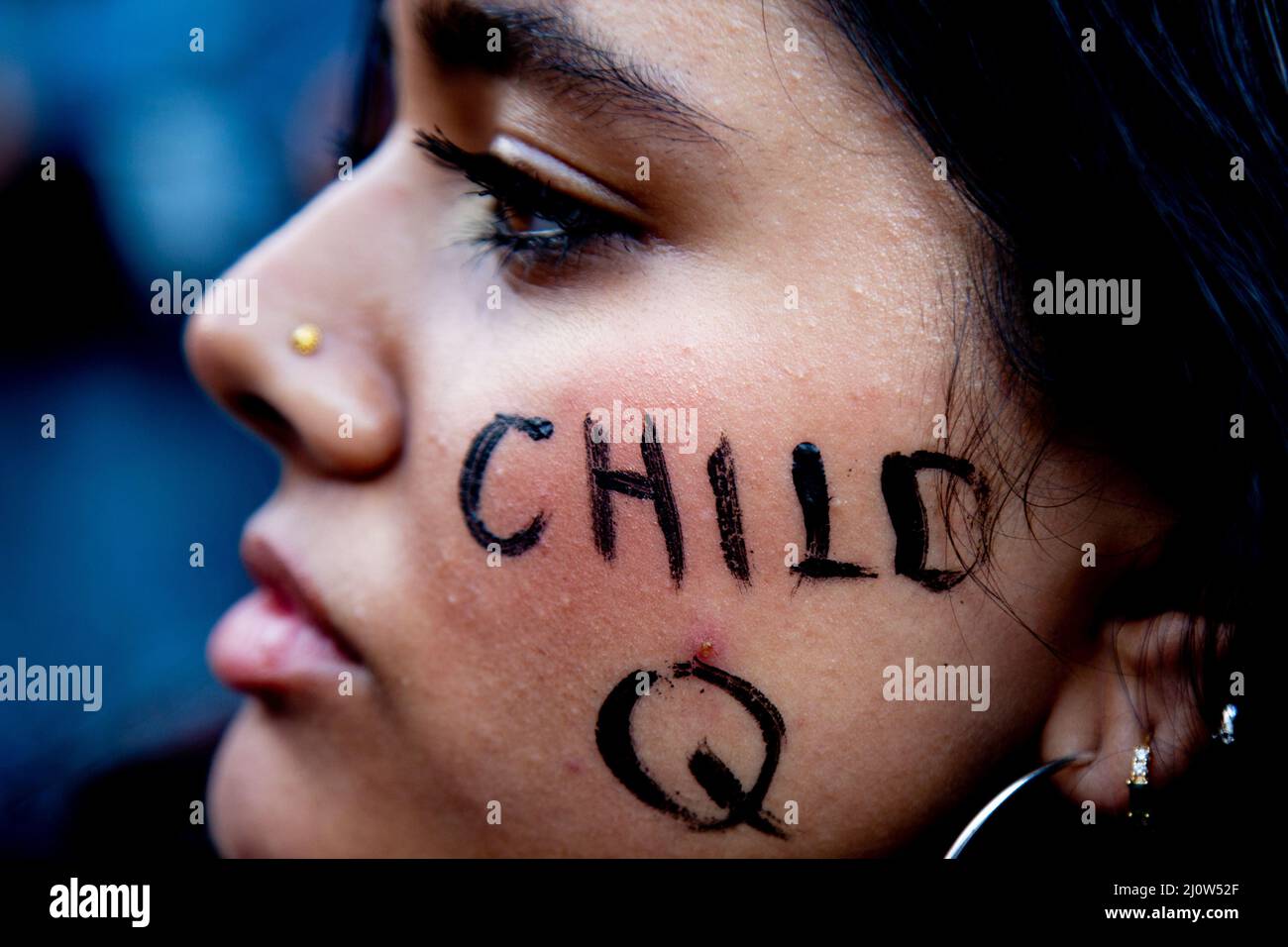 London, UK. 20th Mar, 2022. A woman with Child Q written on her face ...