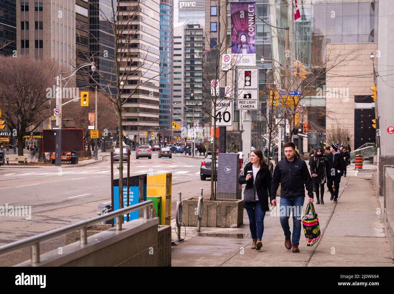 TORONTO, CANADA - 01 04 2020: Pedestrians walking along the sidewalk on ...
