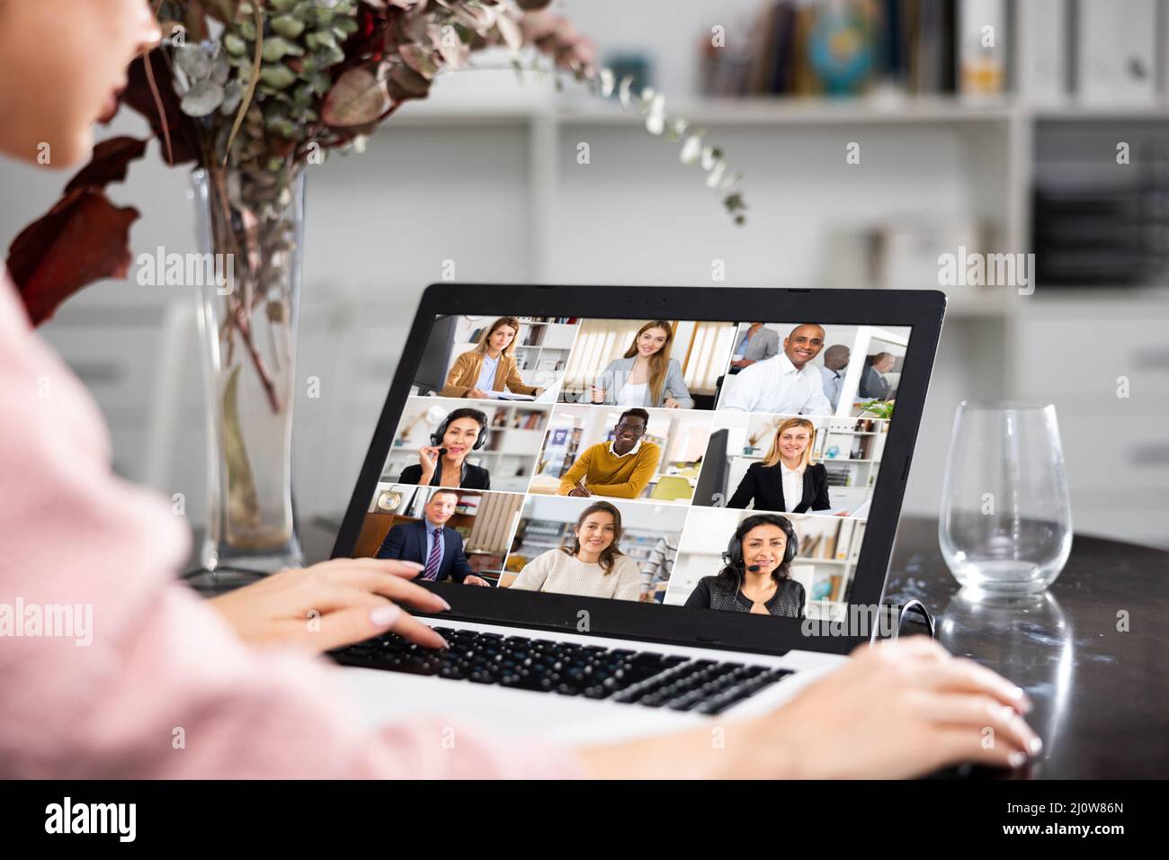 Woman having video call with co-workers at home Stock Photo - Alamy