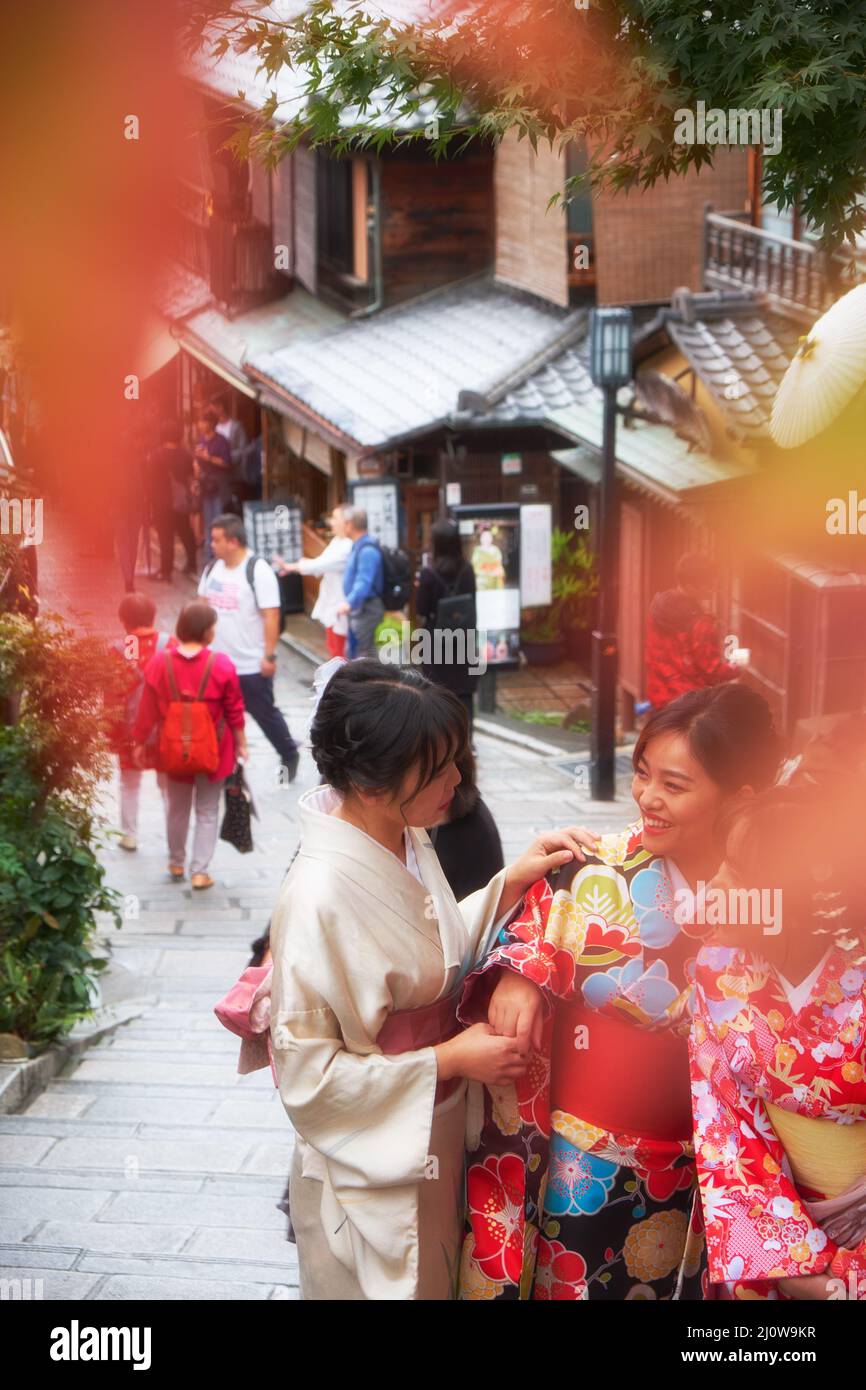 Young girls wearing kimono on the street of old Kyoto neighborhood ...