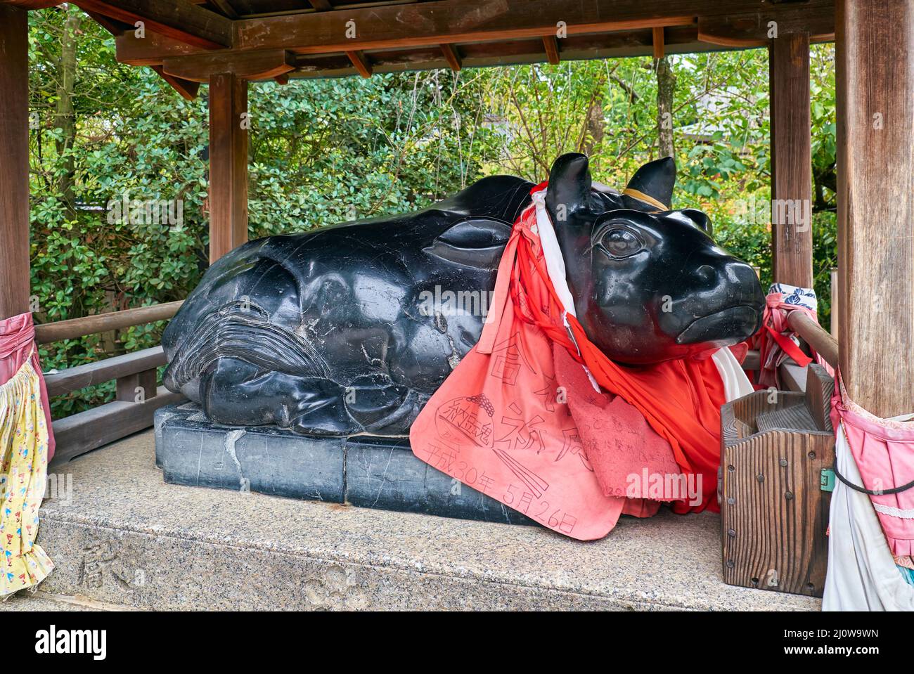 The statue of ox lying down under the roof at Kitano Tenmangu shrine ...