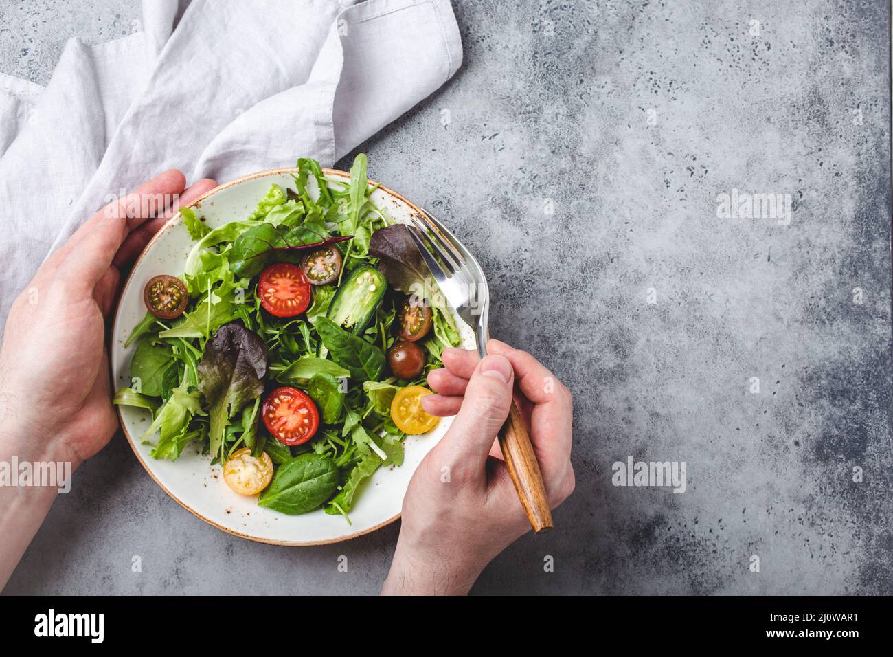 Man eating vegetarian vegetables healthy salad with red and yellow ...