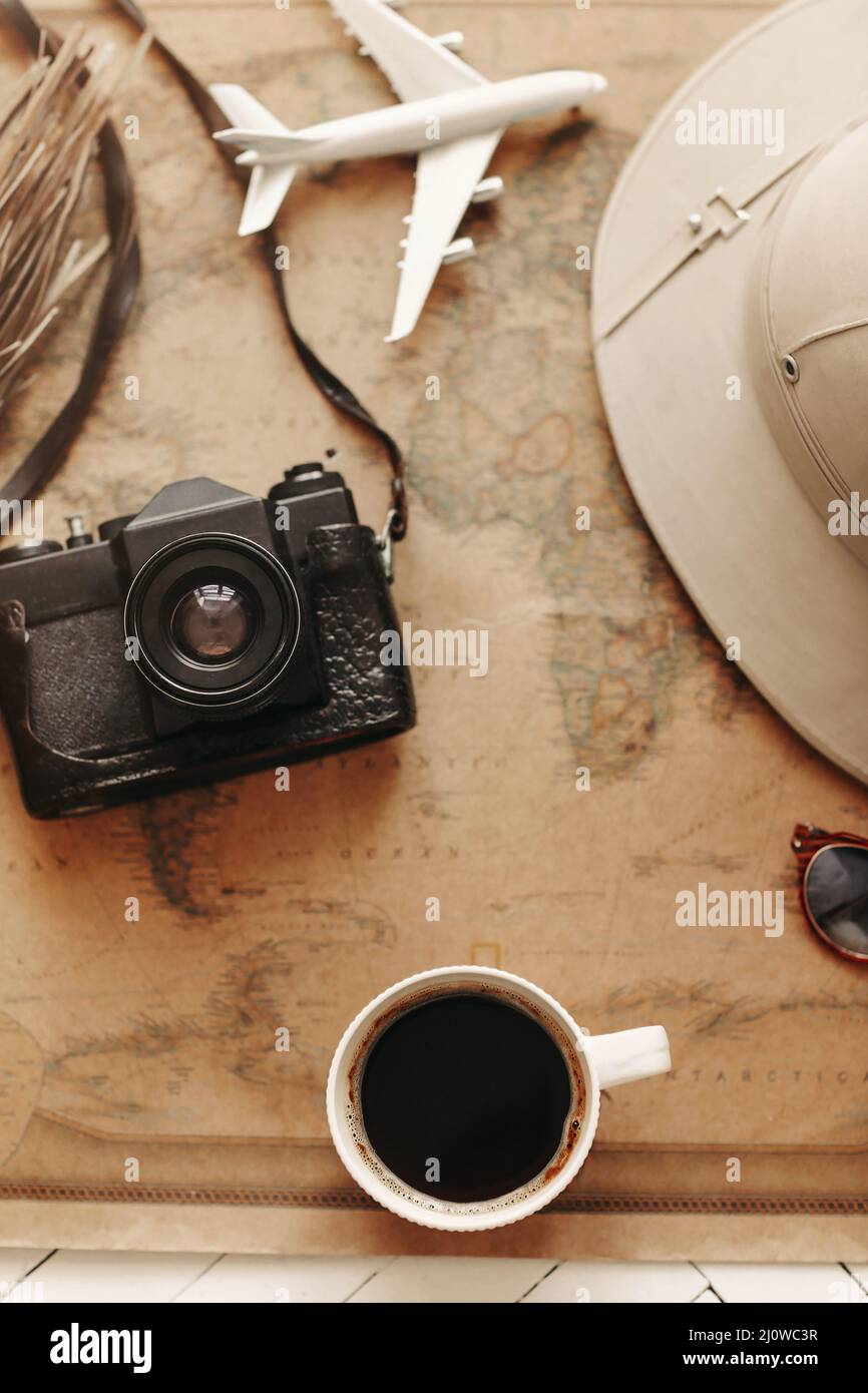 Top View Of Vintage World Map With Objects Related To Journey Excursions And Tours Stock Photo top-view-of-vintage-world-map-with-objects-related-to-journey-excursions-and-tours-stock-photo