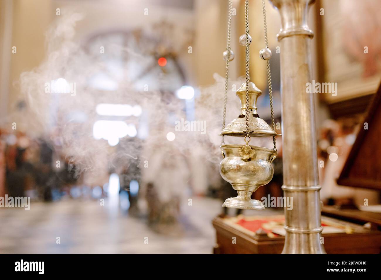 Smoking censer hangs on a stand in a church Stock Photo - Alamy
