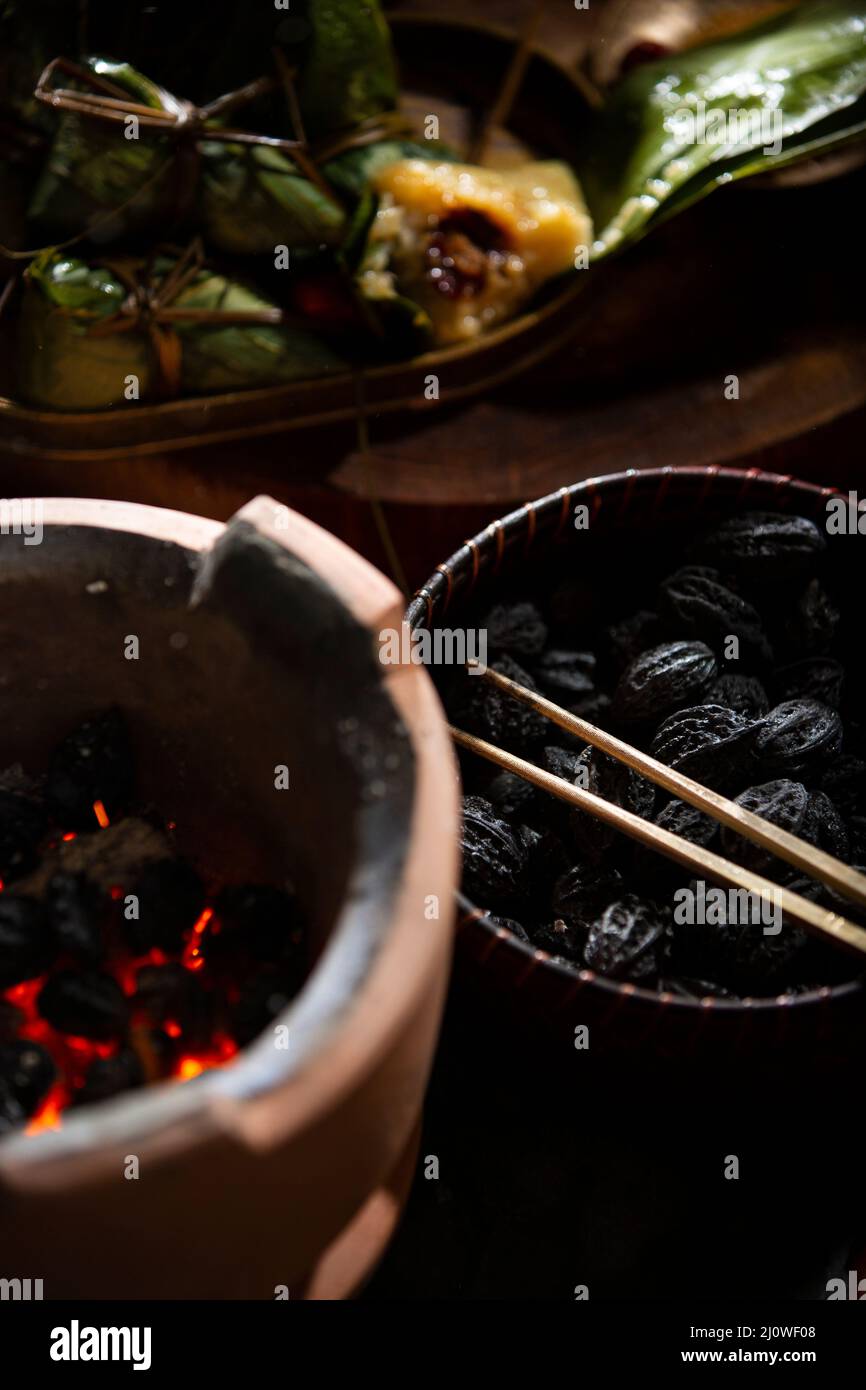 Walnut charcoals and burning charcoal stove Stock Photo - Alamy