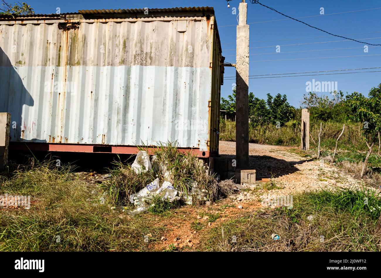Bottle Dumping At The Back Of A Cargo Container Stock Photo - Alamy