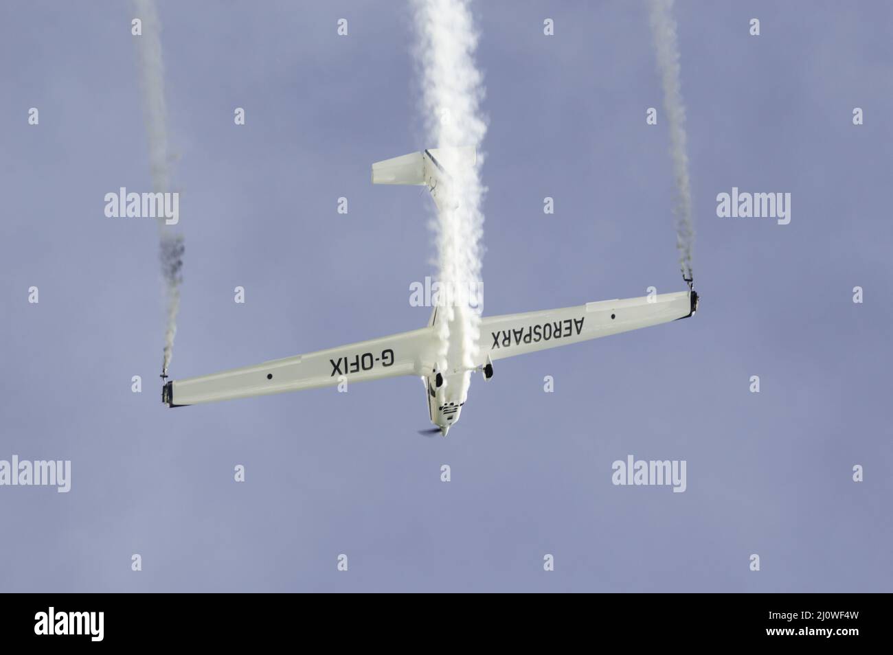 Twin plane acrobatics performance in the sky with smoke Stock Photo - Alamy