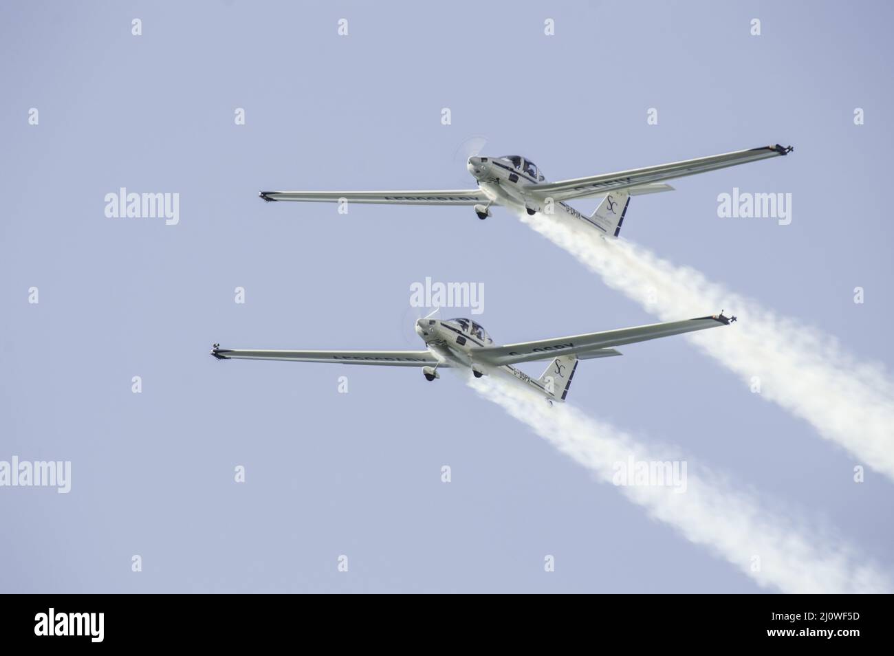 Twin plane acrobatics performance in the sky with smoke Stock Photo - Alamy