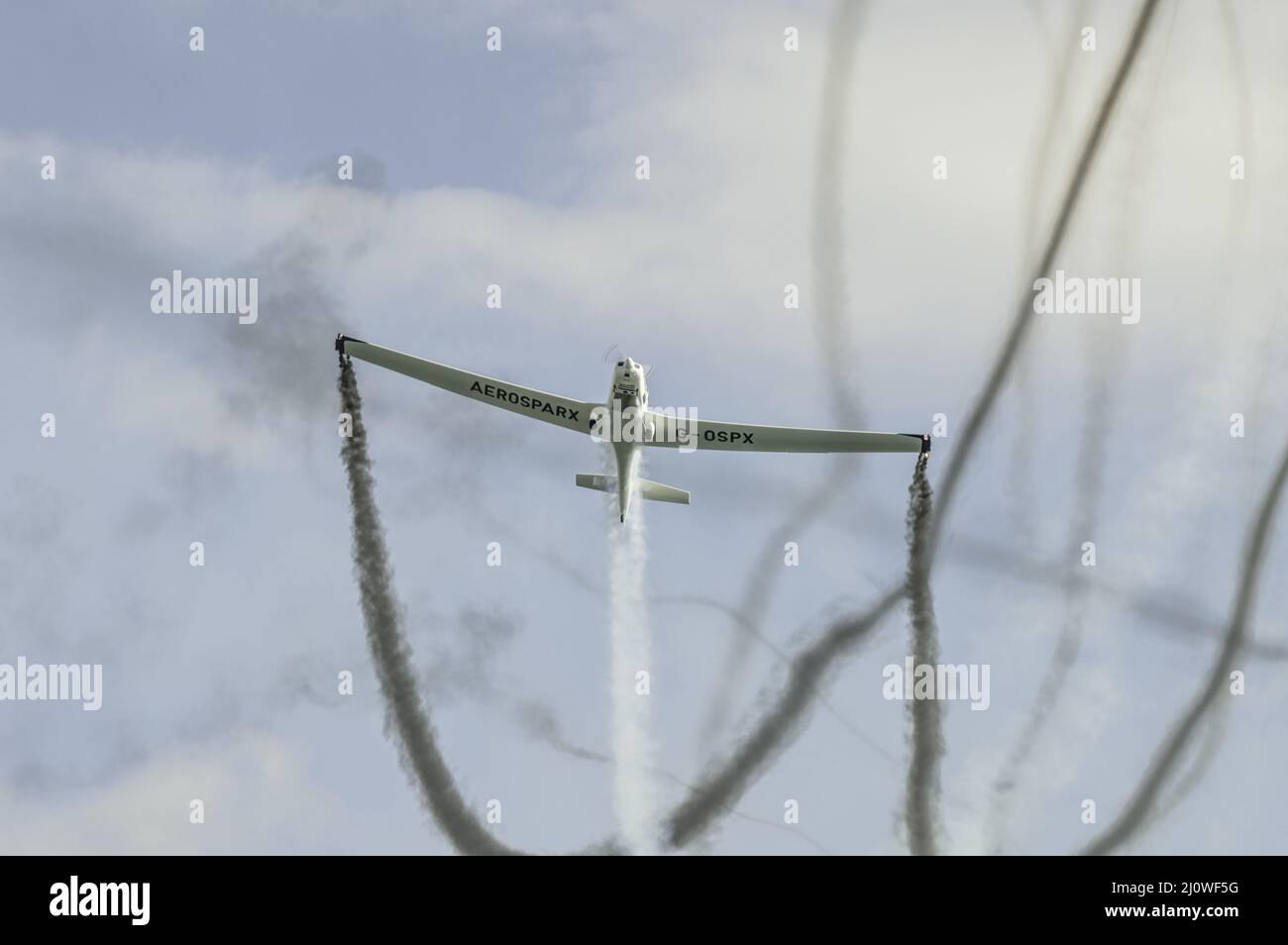 Twin plane acrobatics performance in the sky with smoke Stock Photo - Alamy