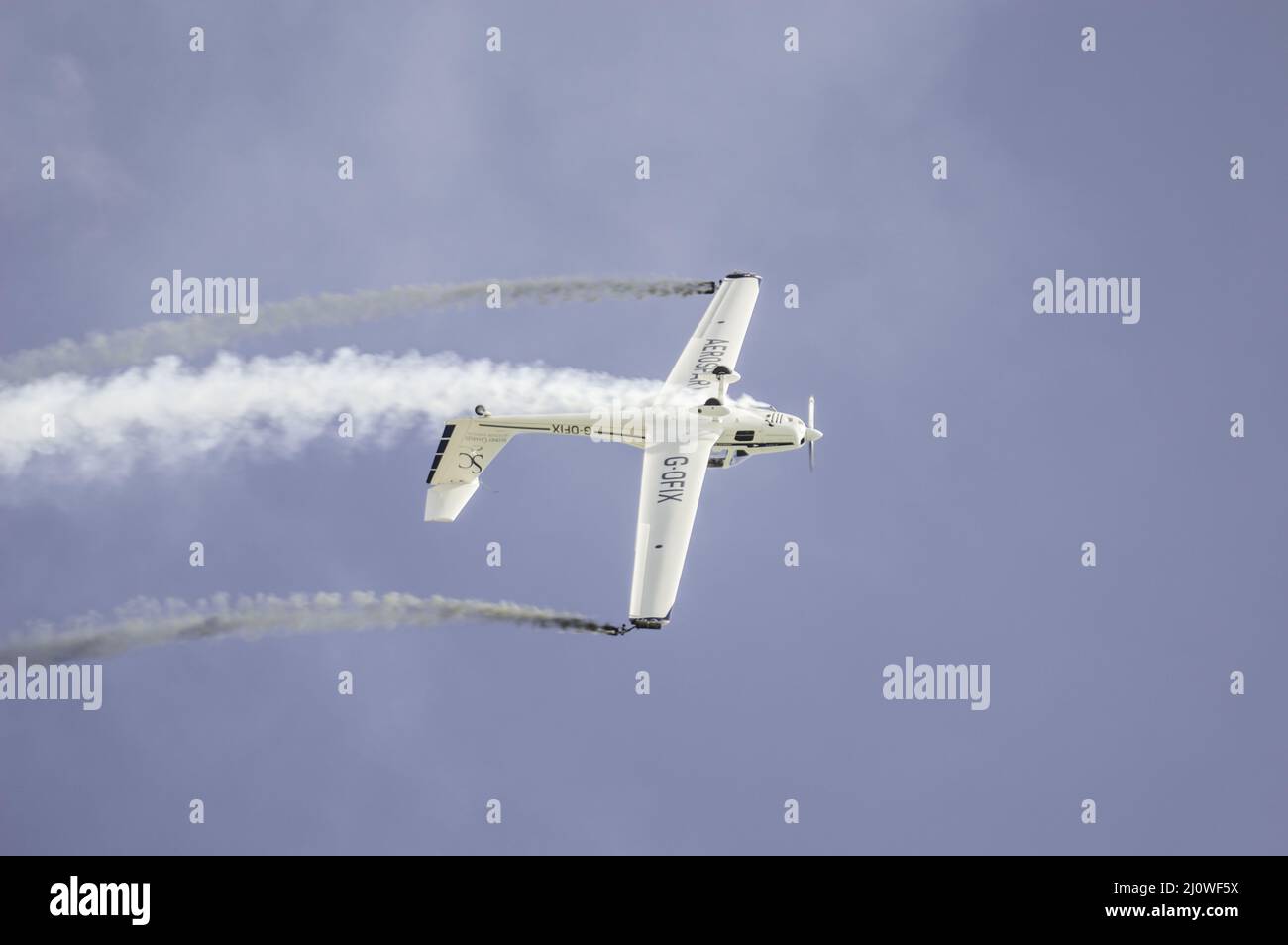 Twin plane acrobatics performance in the sky with smoke Stock Photo - Alamy