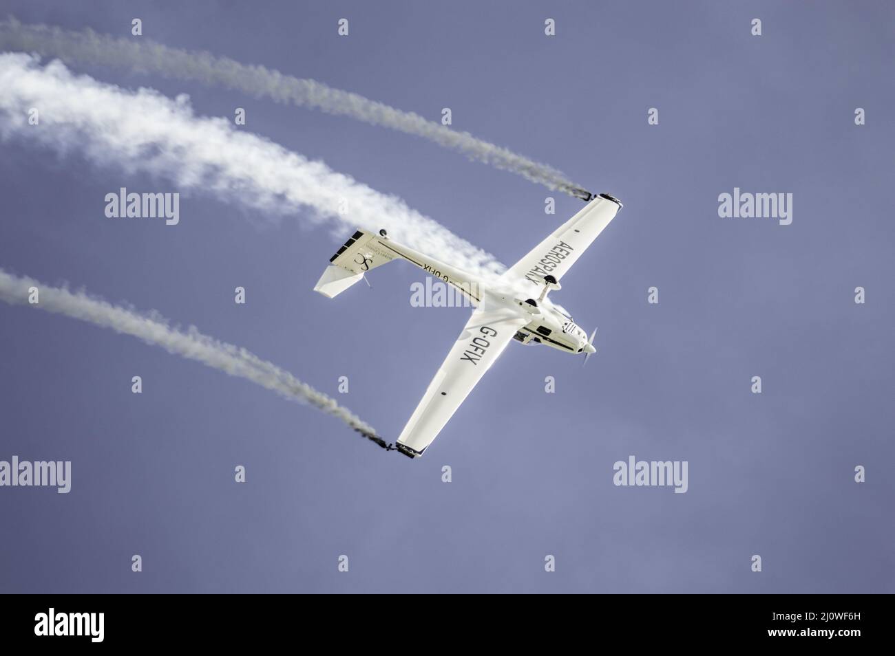 Twin plane acrobatics performance in the sky with smoke Stock Photo - Alamy