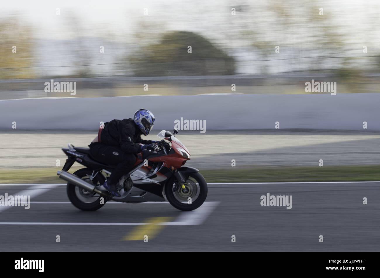 Classic racing sport motorbike running in the asphalt track Stock Photo ...