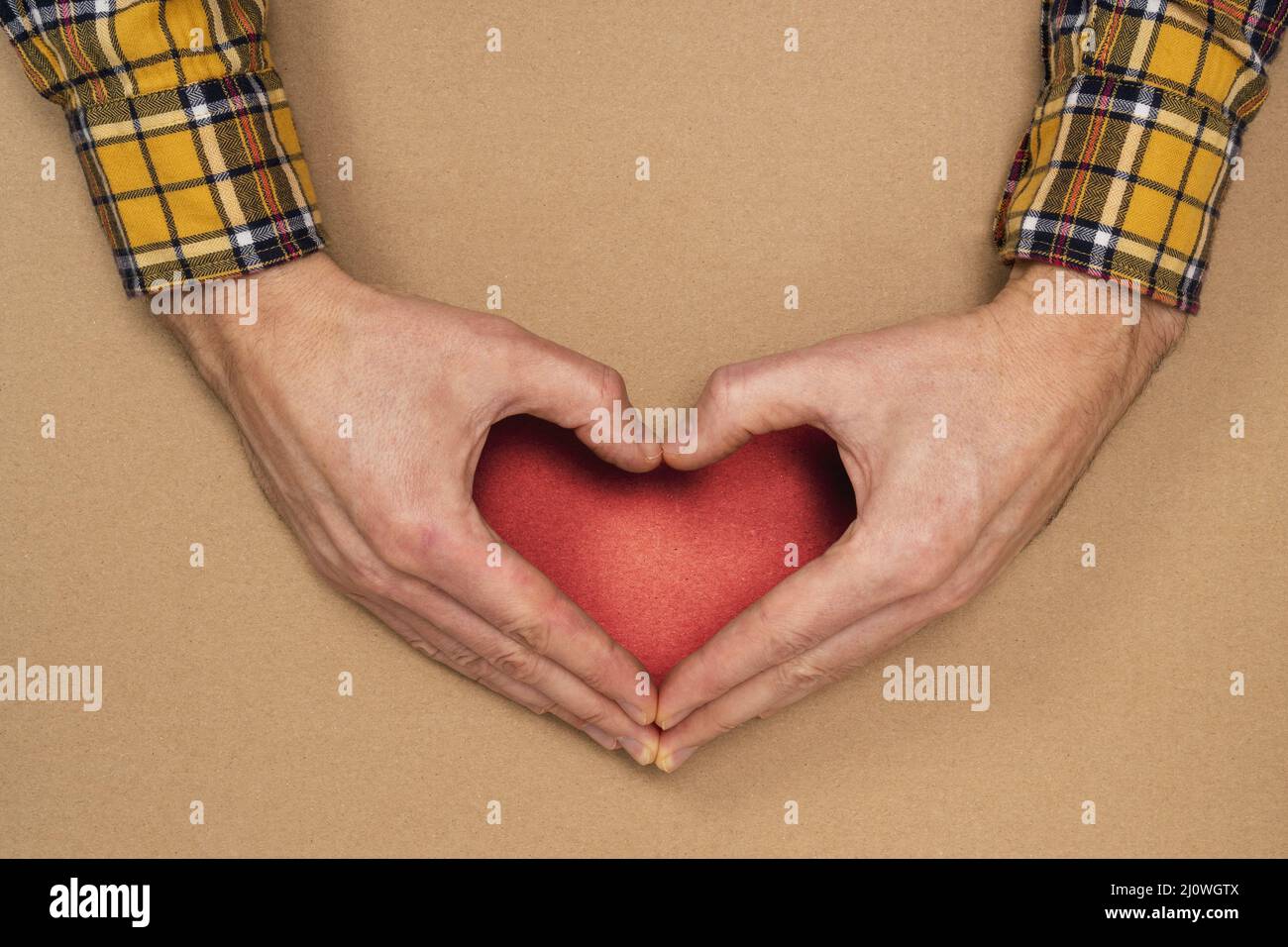 Shape of the heart made by hands Stock Photo - Alamy