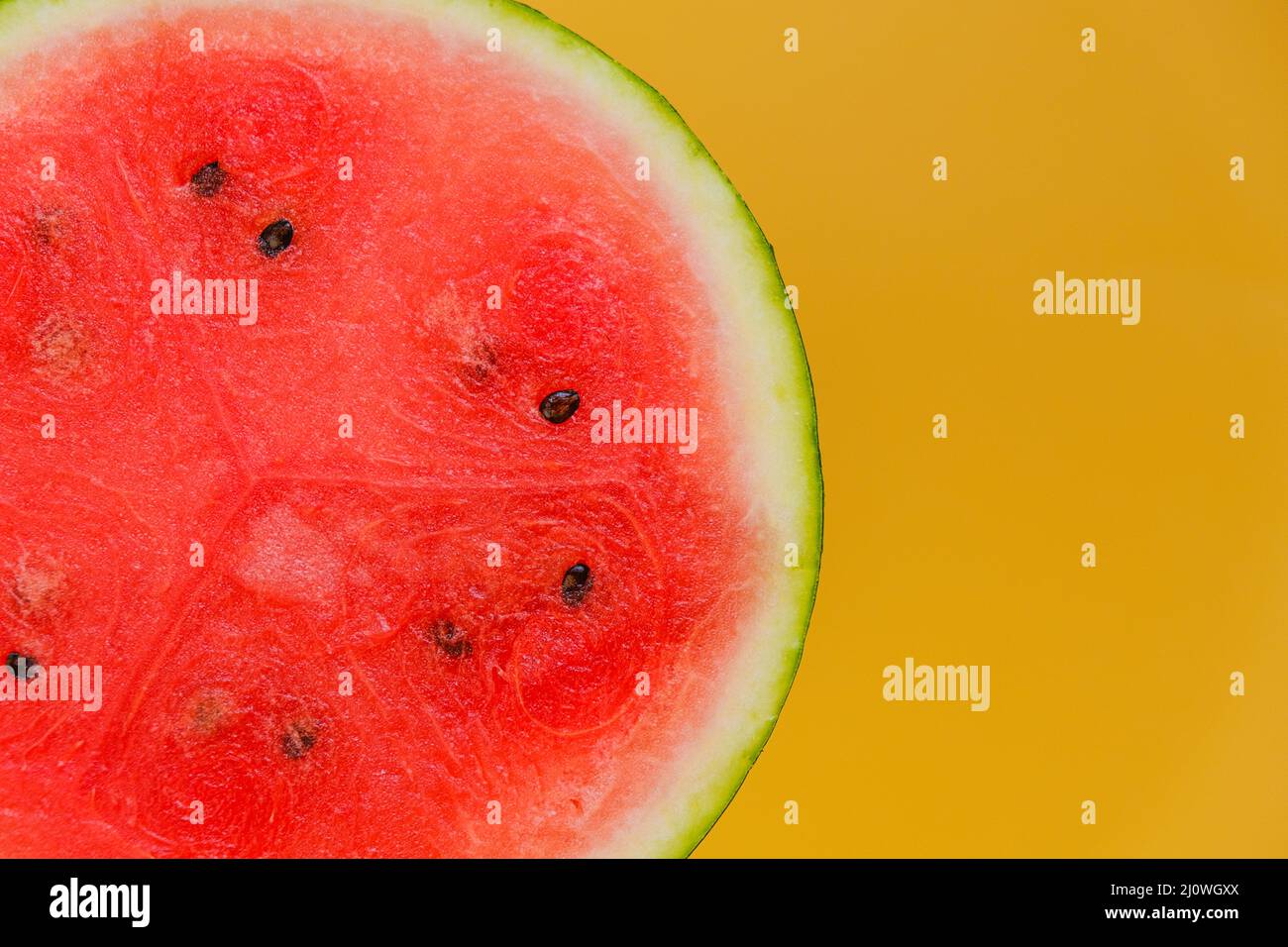 Watermelon pulp close-up. Watermelon cut on a yellow background. red ...