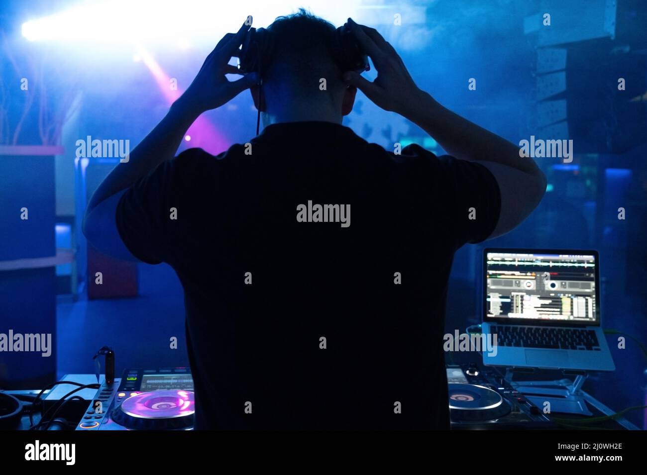 Dj mixing at party festival with light and smoke in background - Summer ...