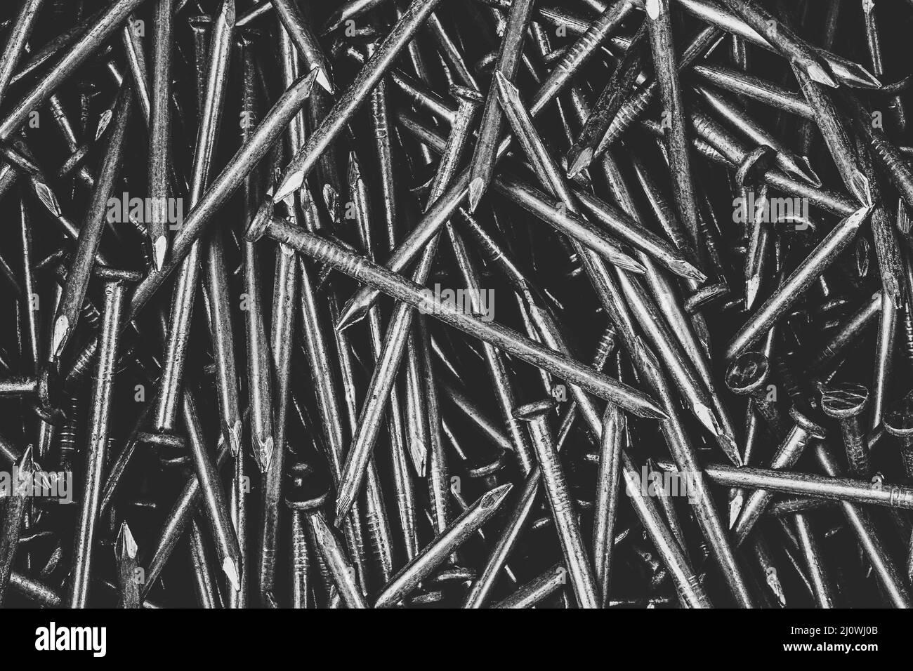 A bunch of metal nails close-up top view, black and white photo Stock ...