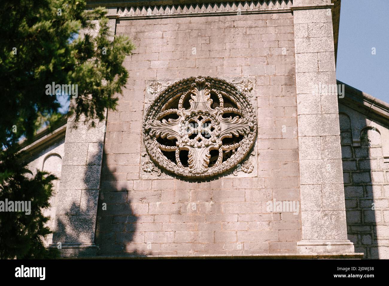Rose window on the stone facade of an old church Stock Photo - Alamy