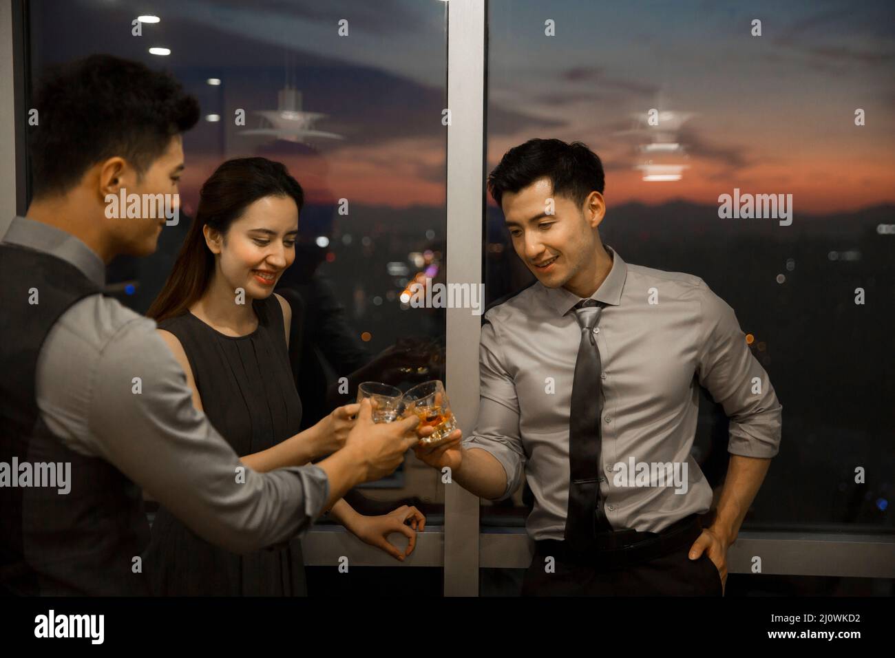 Chinese business colleagues toast to celebrate success in the office ...