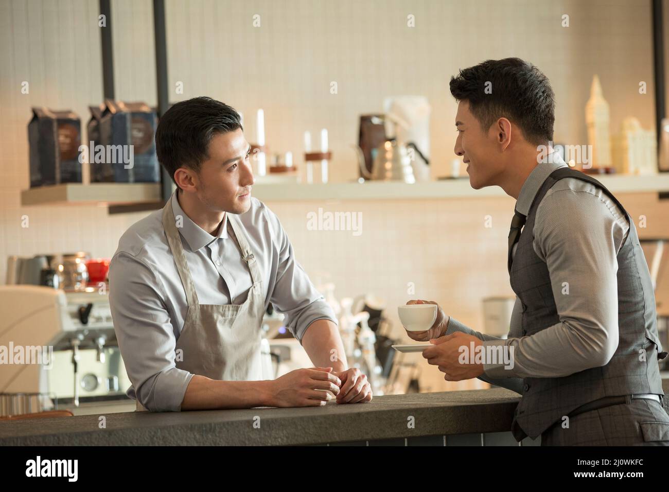 A barista serving a customer in a coffee shop Stock Photo - Alamy