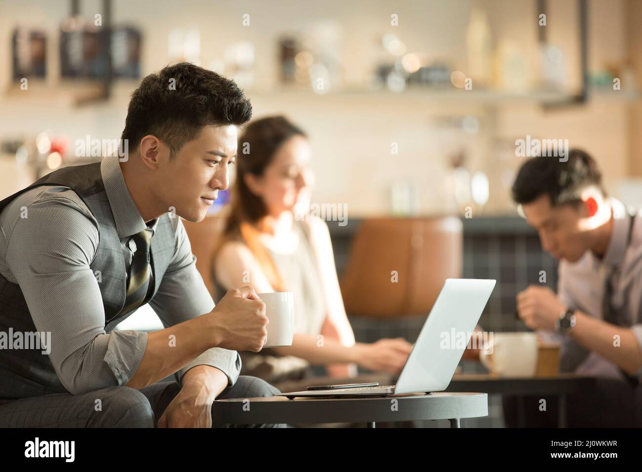 Chinese business man work in cafe Stock Photo - Alamy