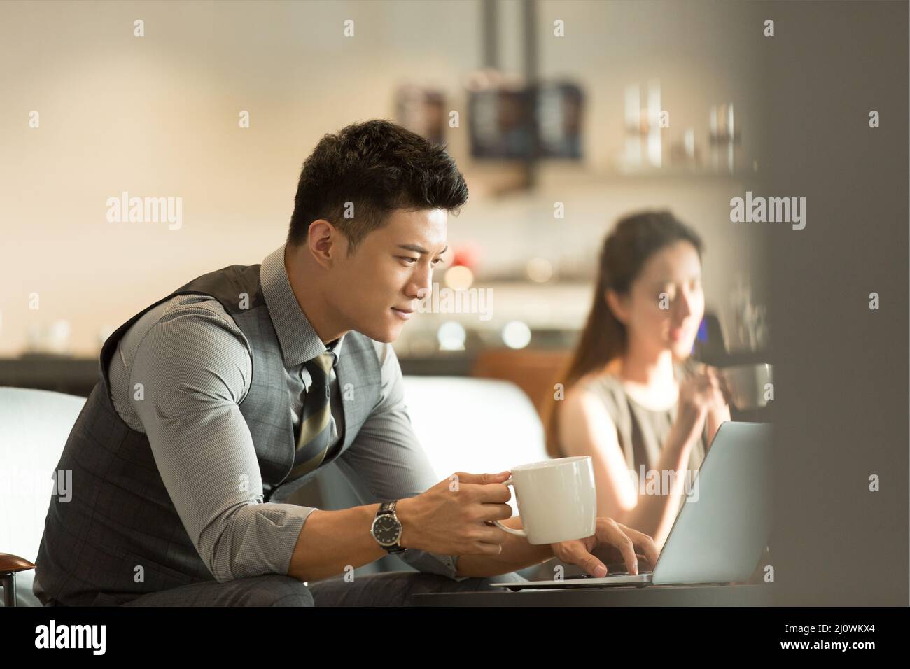 Chinese business man work in cafe Stock Photo - Alamy