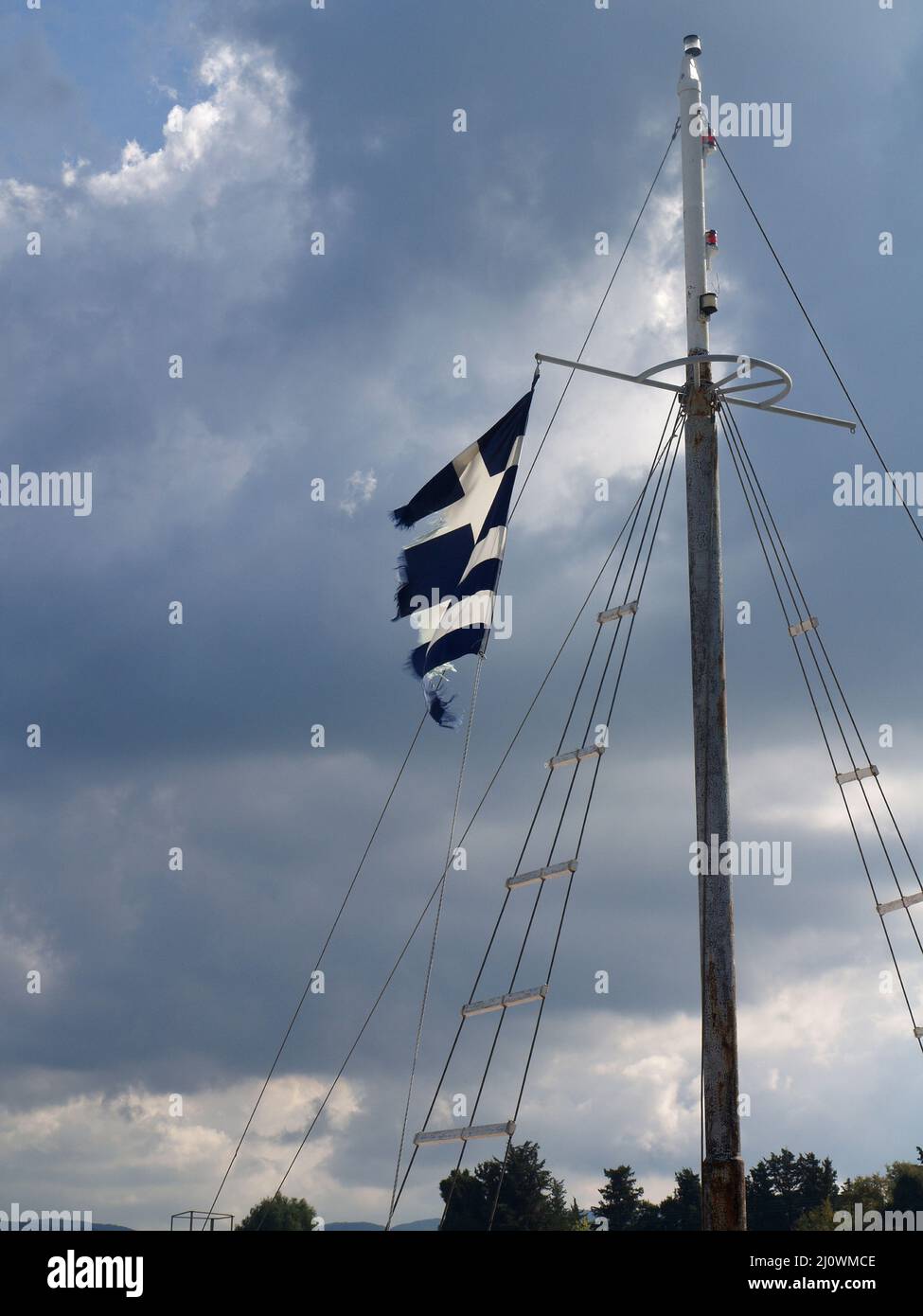 Tettered Greek flag flying from boat's mast at Astrakeri, Corfu, Greece ...