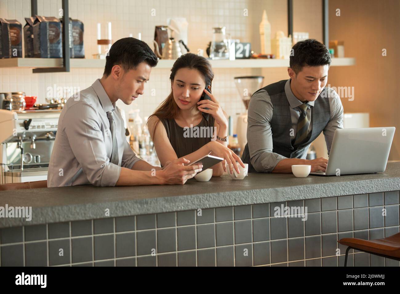 Close-up of successful Chinese business colleagues work in coffee shops ...