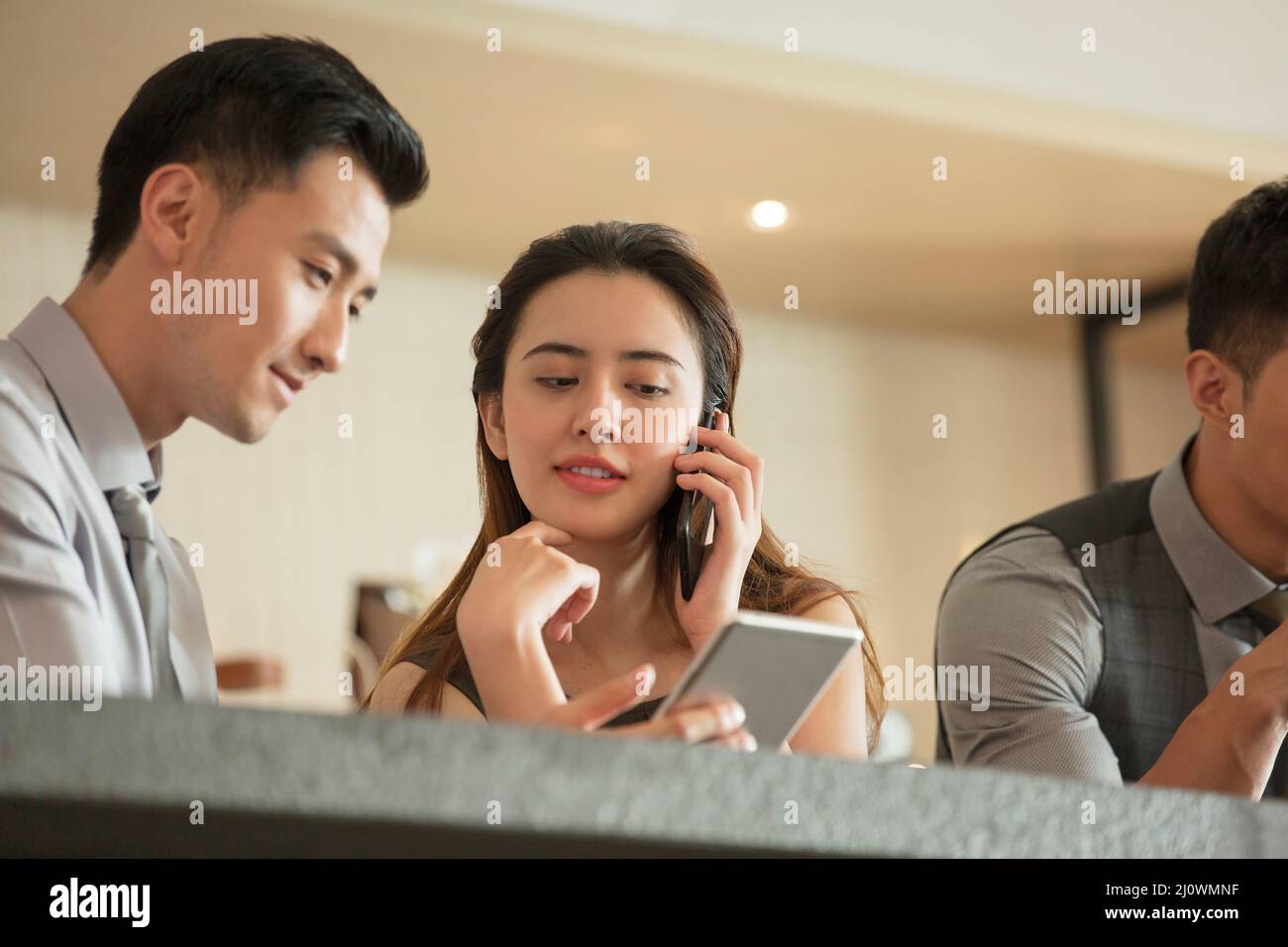 Close-up of successful Chinese business colleagues work in coffee shops ...