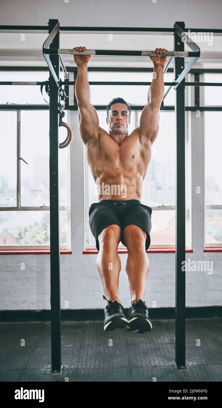 Aim high. Shot of a muscular man working out in a gym Stock Photo - Alamy