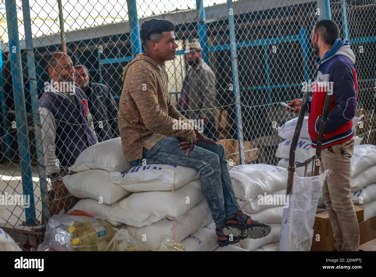 Gaza, Palestine. 20th Mar, 2022. Palestinians collect food aid from a ...