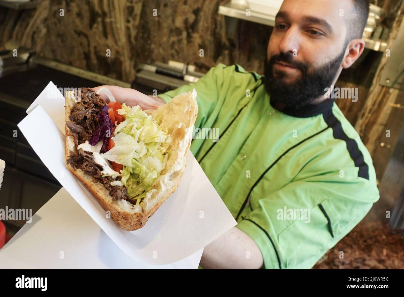 Berlin, Germany. 19th Mar, 2022. Galip from Imren Grill prepares a ...