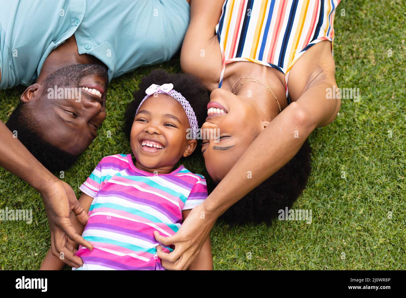 High angle view of cheerful african american parents lying with ...