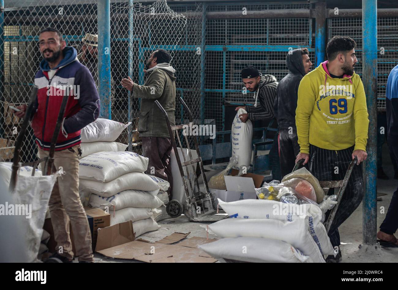 Gaza, Palestine. 20th Mar, 2022. Palestinians collect food aid from a ...