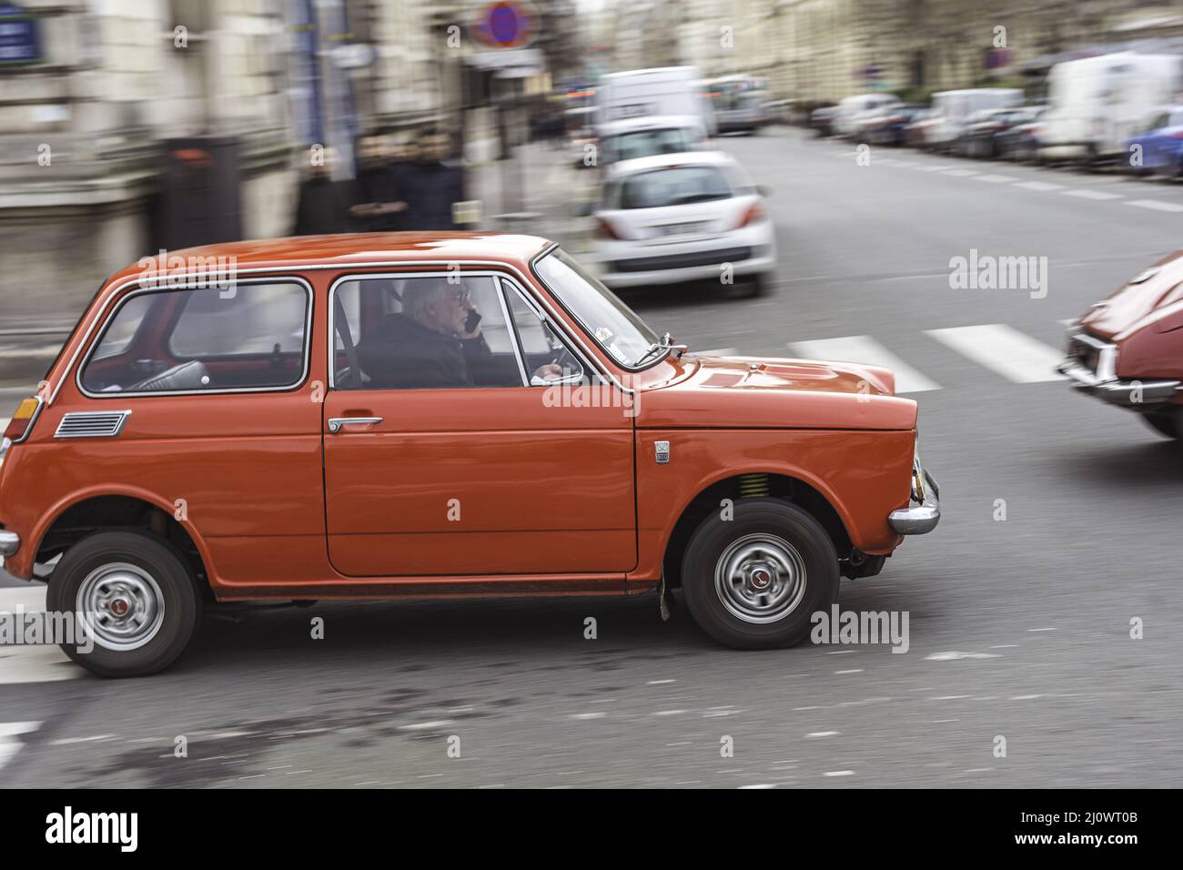 Little red Honda N360 car running in the city Stock Photo - Alamy