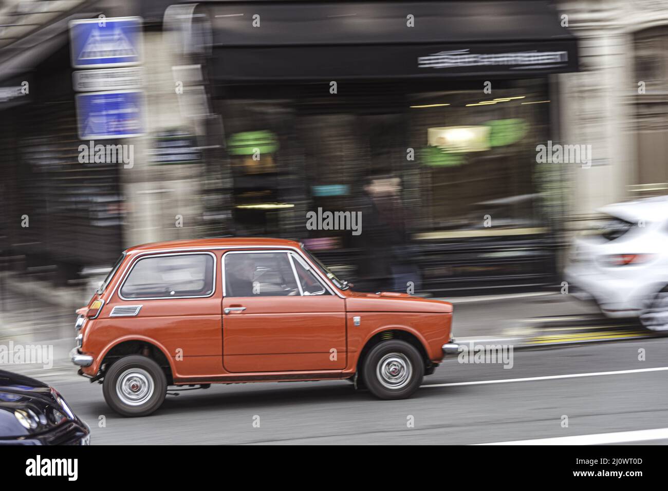 Little red Honda N360 car running in the city Stock Photo - Alamy