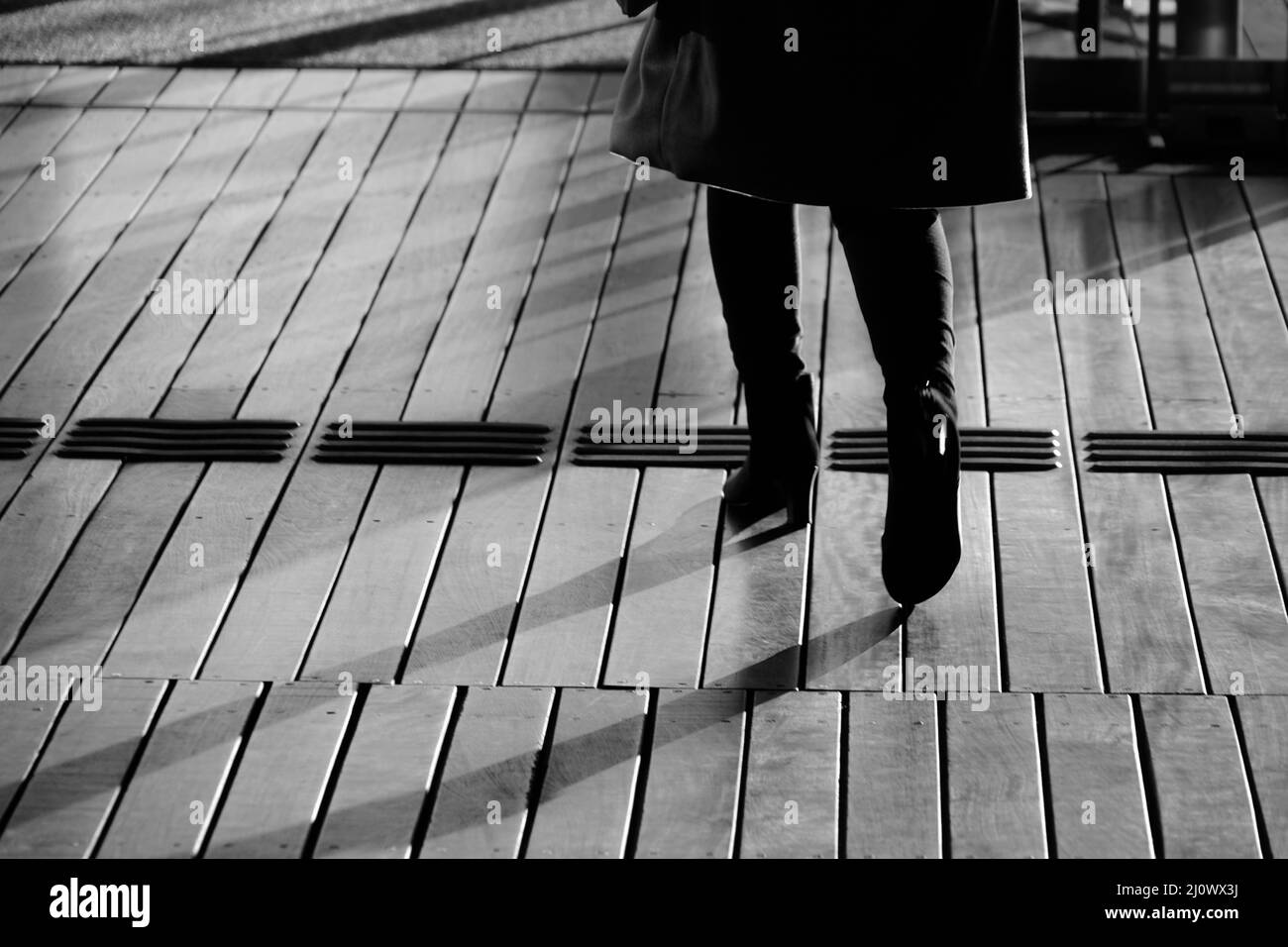 Shadow of people that walk the wood deck Stock Photo - Alamy