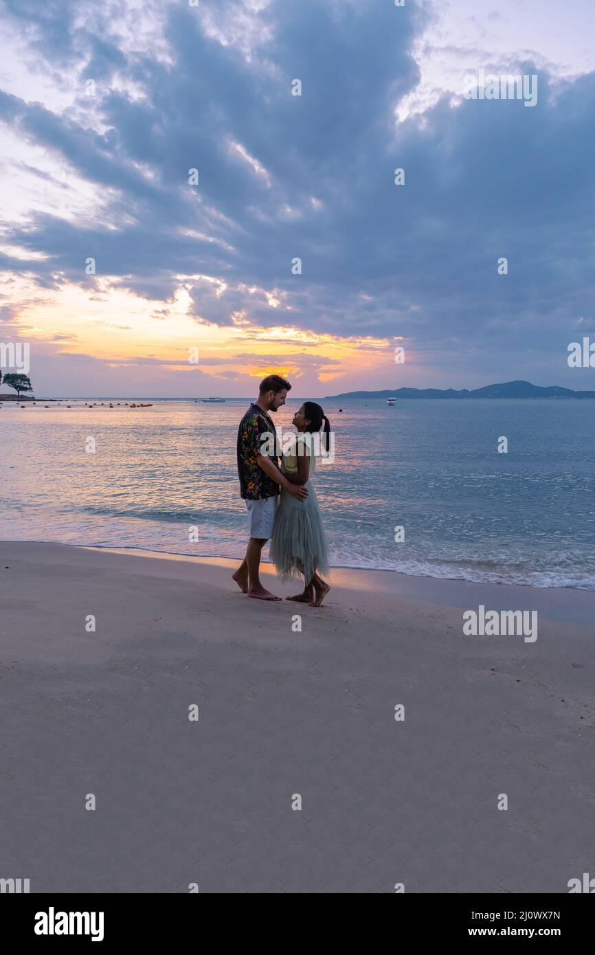 Man and woman walking into sunset hi-res stock photography and images ...