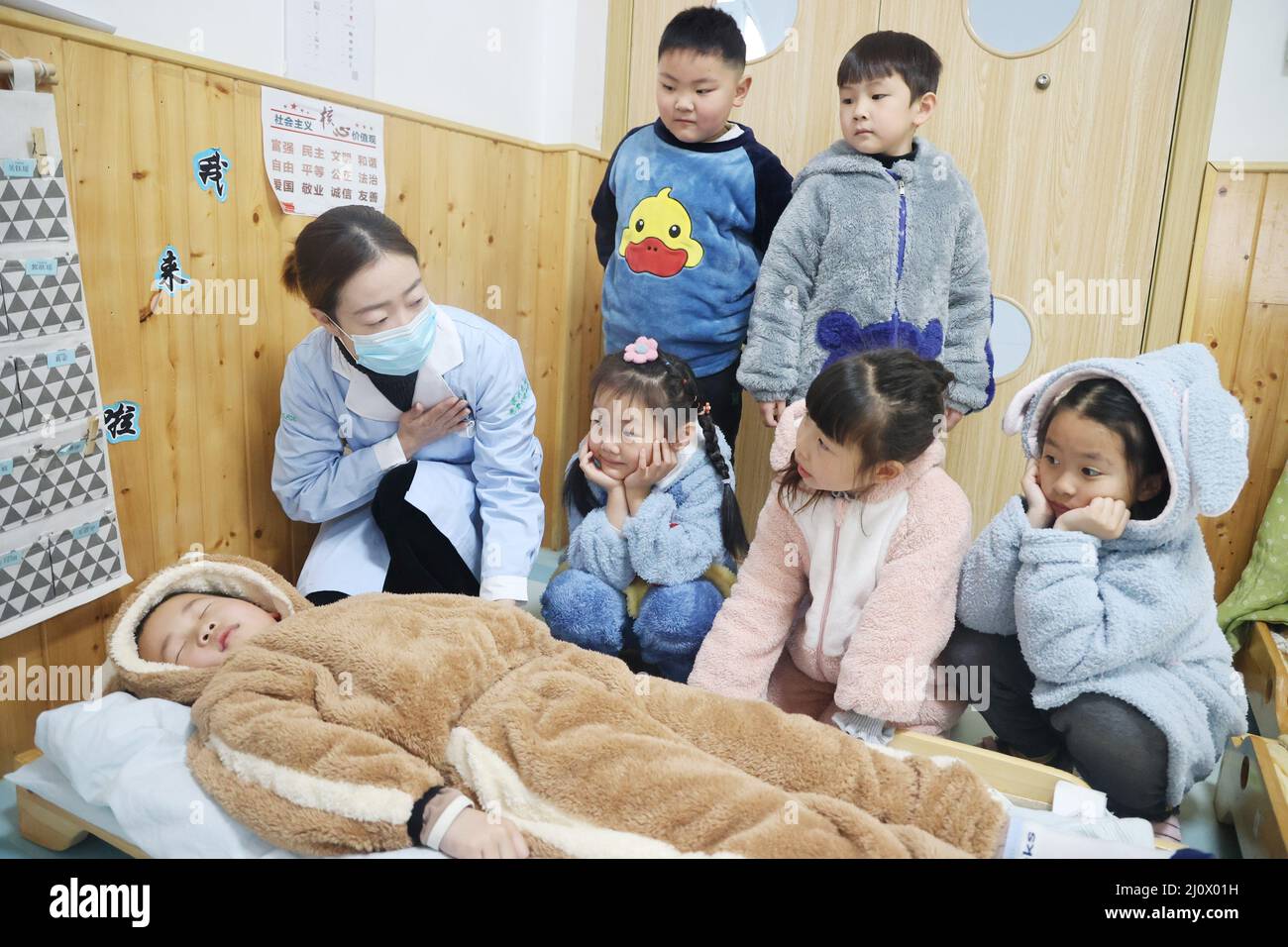 NANTONG, CHINA - MARCH 21, 2022 - Medical staff instruct children to ...