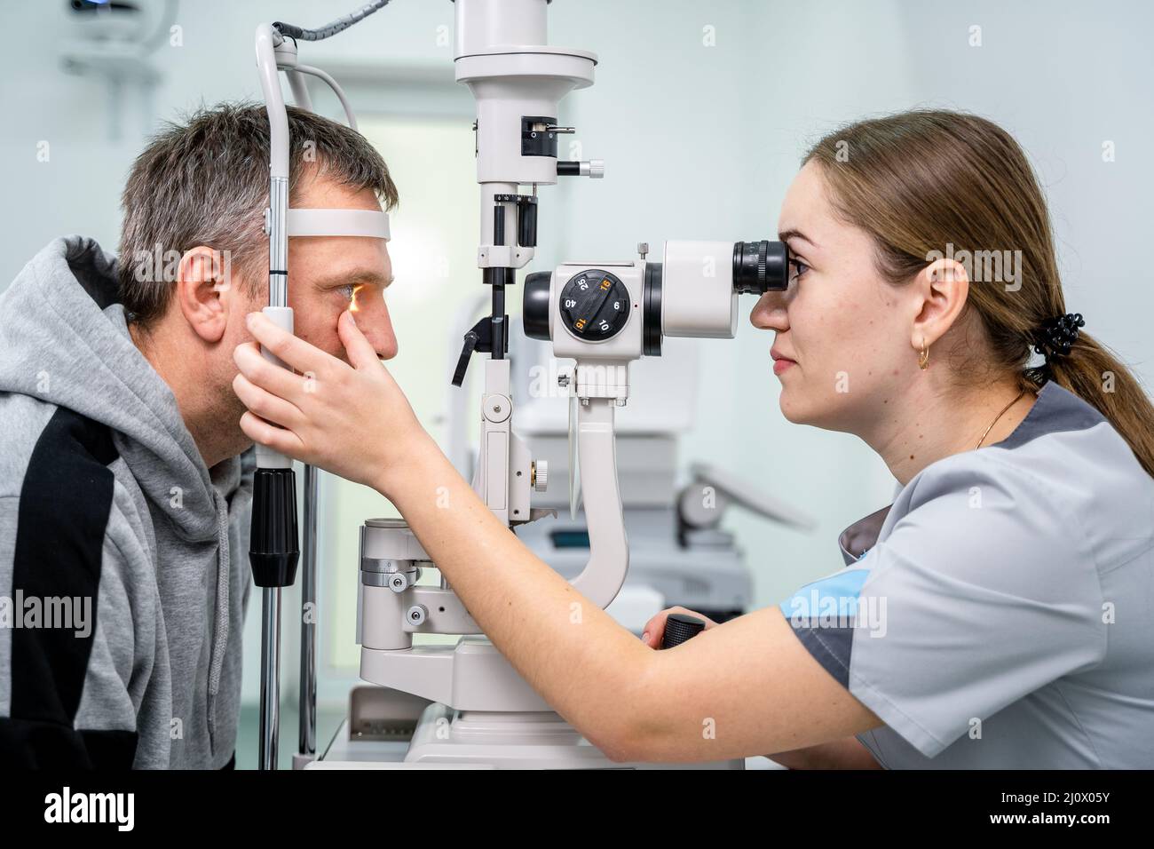 Doctor and patient in ophthalmology clinic. Male patient checking ...