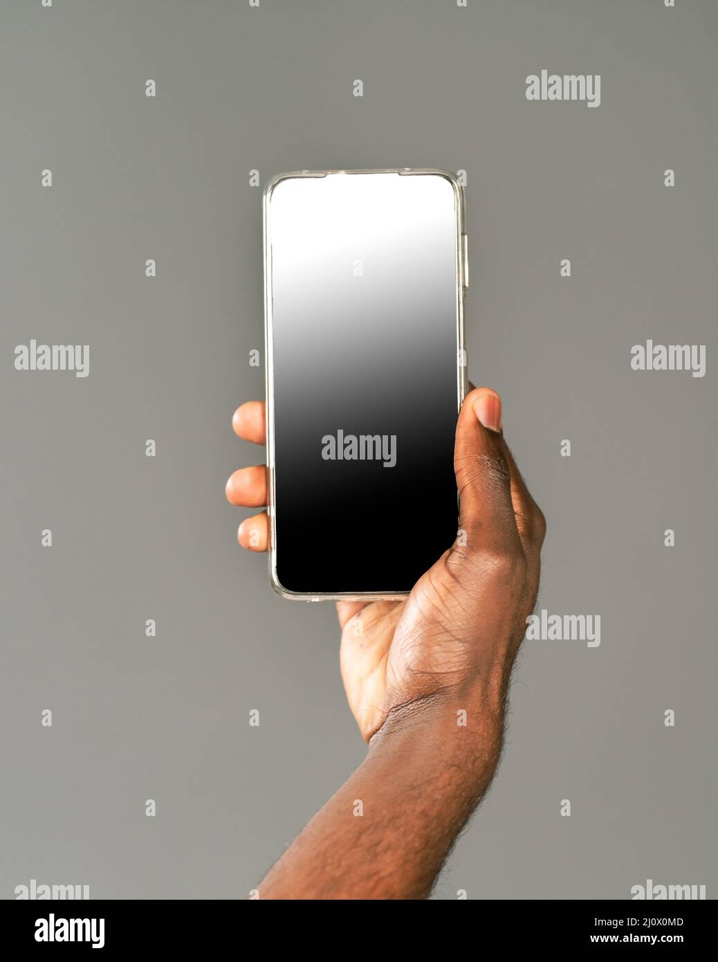 African american man holding smartphone with black screen on camera ...