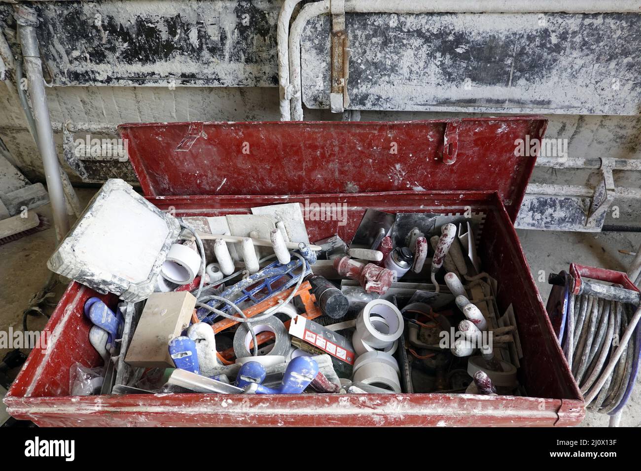 Metal box with dirty tools for plastering Stock Photo - Alamy