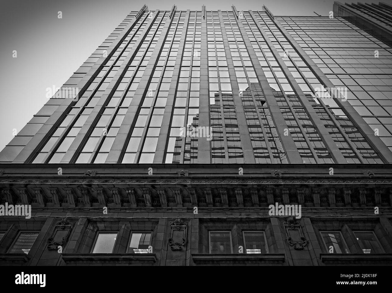 Urban geometry. A wall of high-rise building with large windows ...