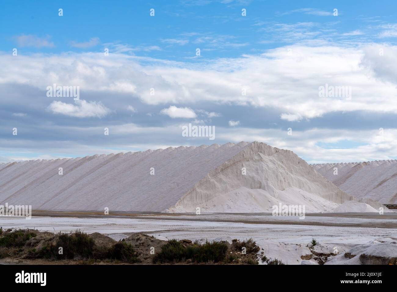 Detail view of large hills of industrial sea salt in the Santa Pola ...