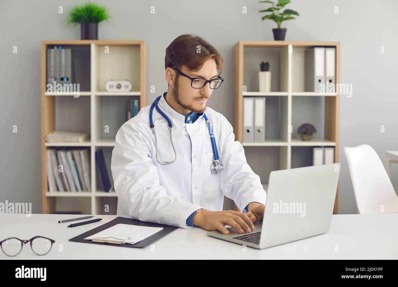 Cardiologist typing report on laptop hi-res stock photography and ...