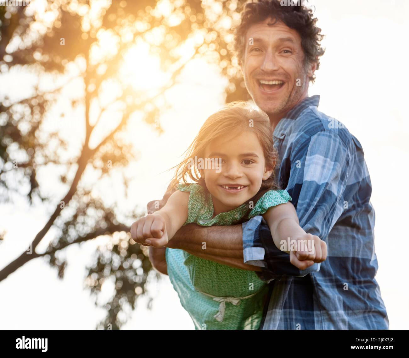 Encourage her courage. Portrait of a happy father playfully carrying ...